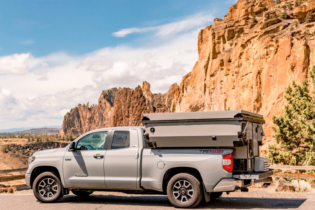 Electrically expandable pickup camper morphs into hard-walled cabin