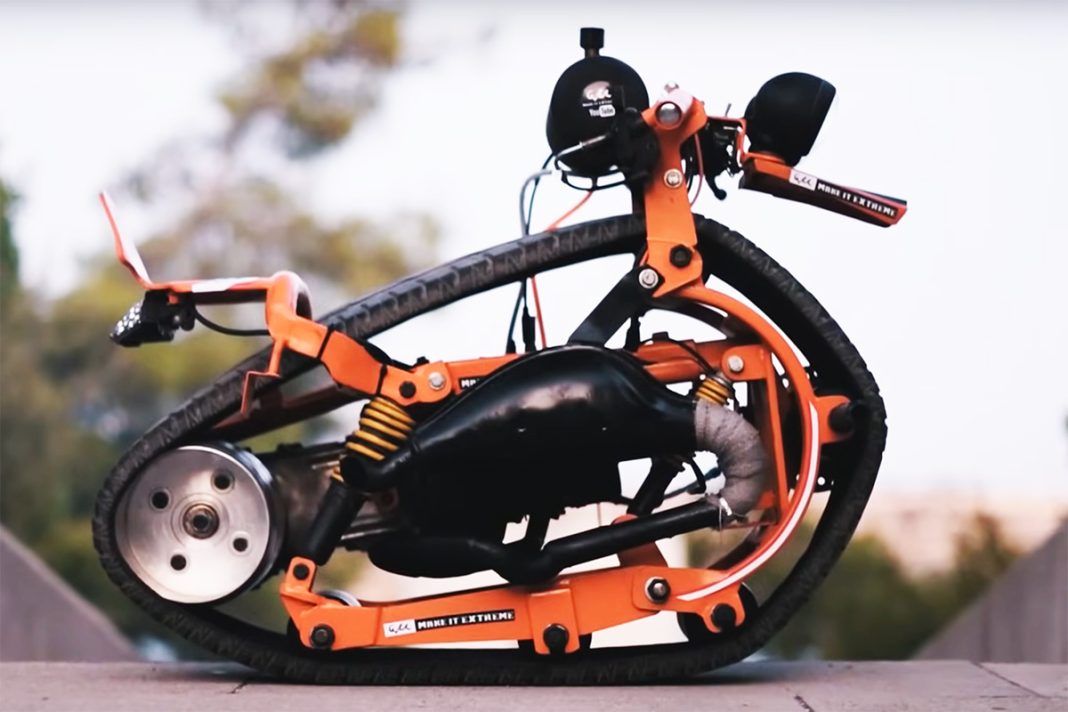 Single-wheel, recycled-tire mini motorbike leans back for wheelies