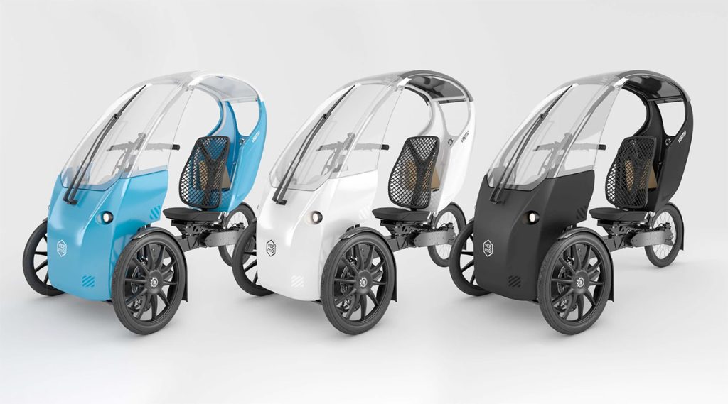 Semi-enclosed, three-wheeled, pedal-powered vehicle with electric assist