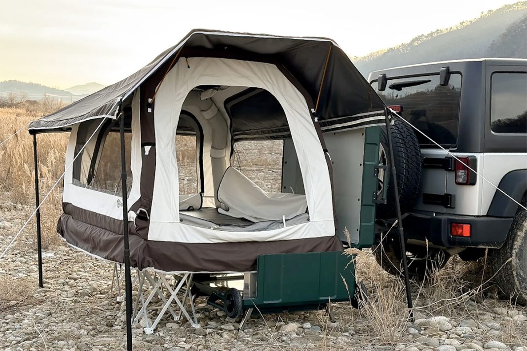 Hitch-mounted tent rolls out and inflates for elevated camping