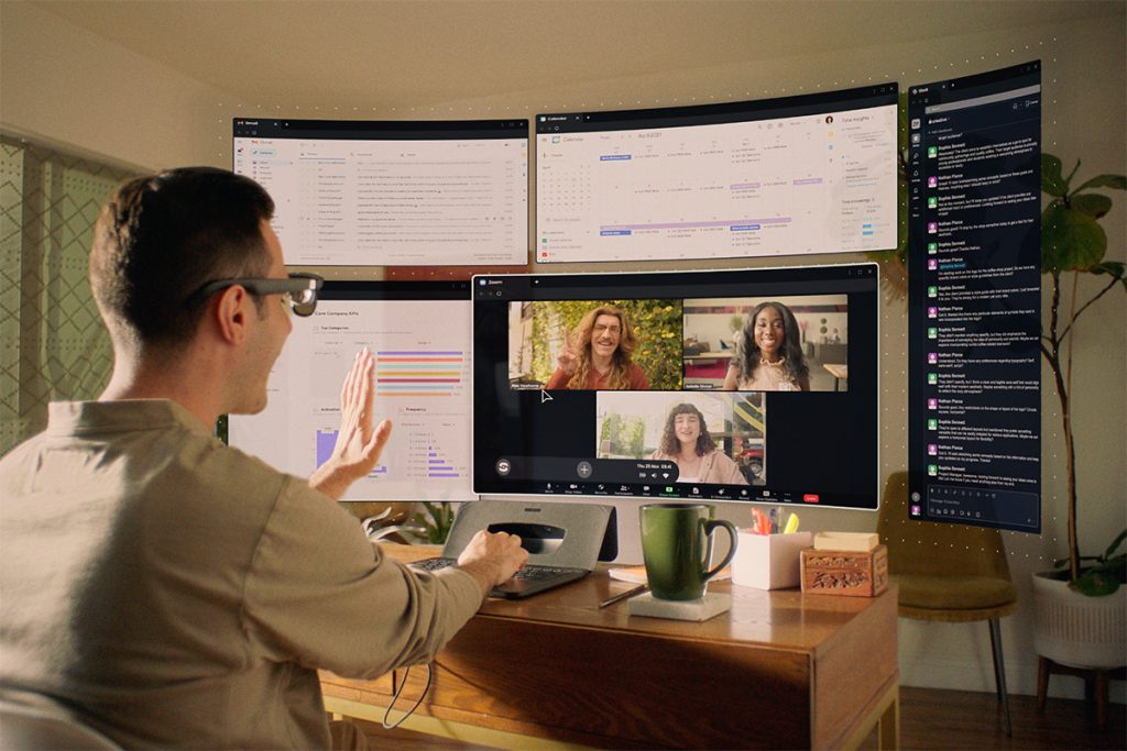 AR laptop with glasses projects floating screens in front of users