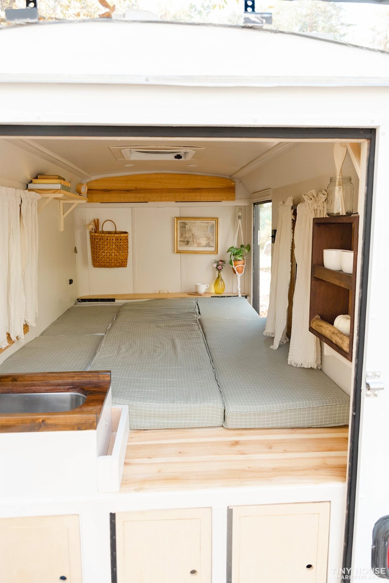Old cargo trailer transformed into a compact tiny house on wheels