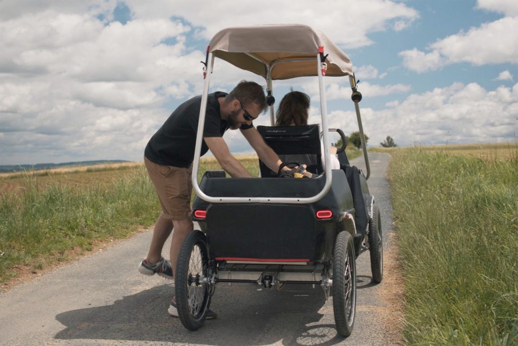 Electric-assisted quadcycle with weather protection offers second car alternative